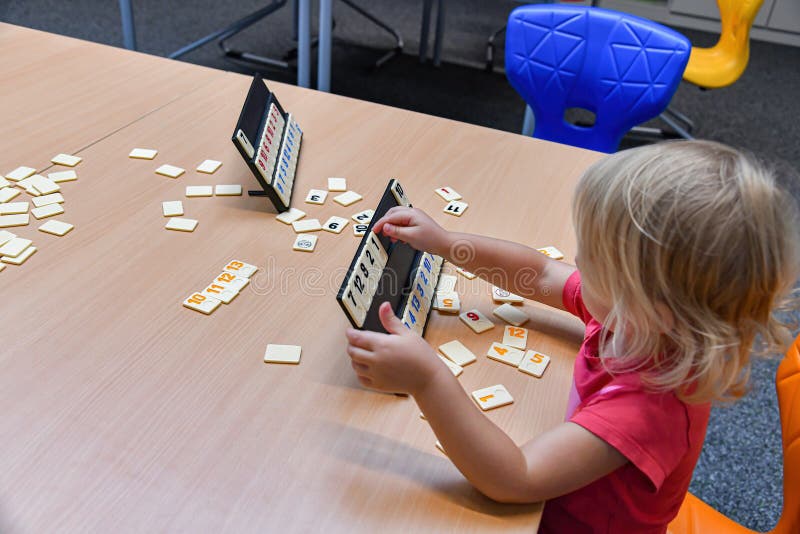 A Little Girl Puts the Chips with Numbers in Order Stock Image - Image ...
