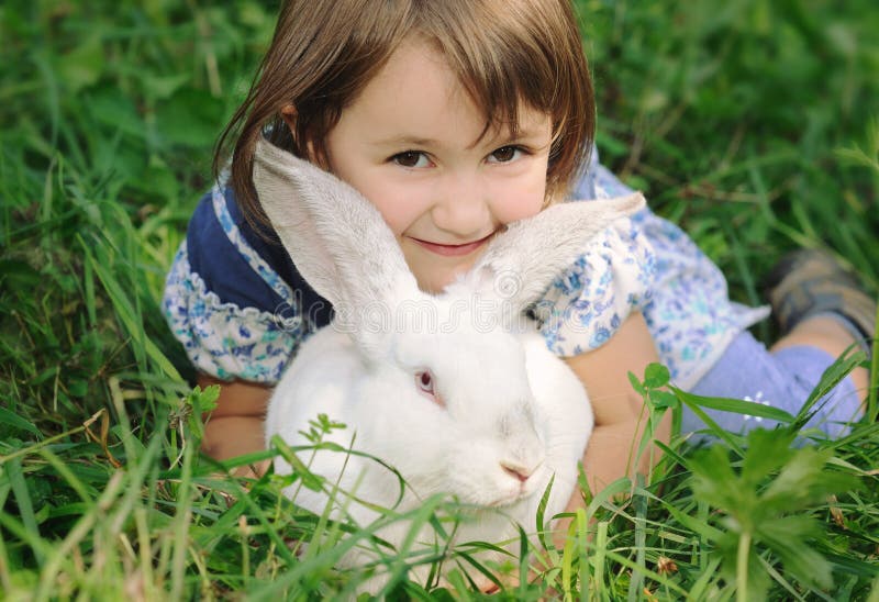 Little girl with rabbit stock photo. Image of childhood - 64537268