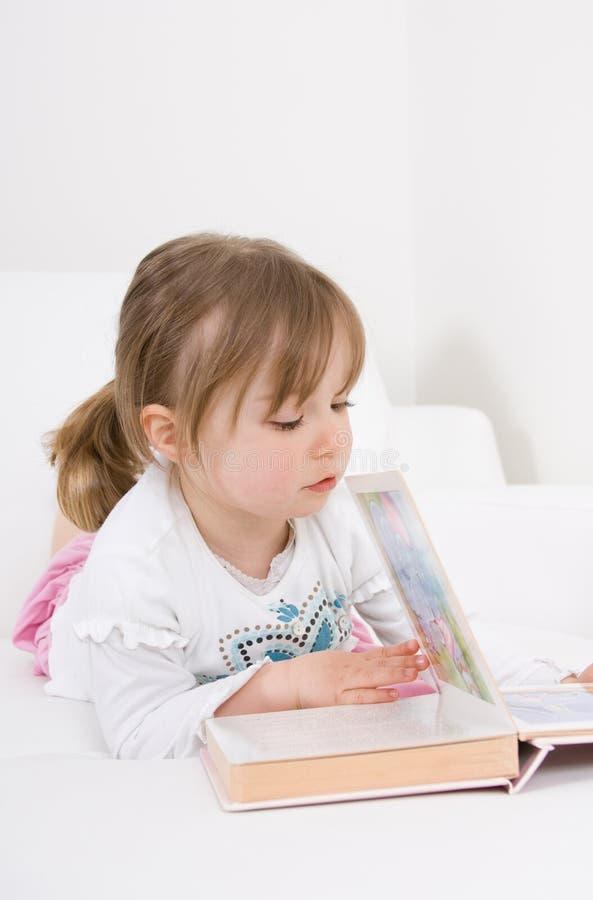 Little girl reading book stock image. Image of innocence - 14289623