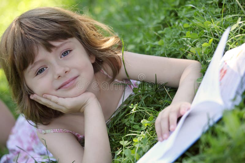 Little girl reading a book stock image. Image of green - 15413635
