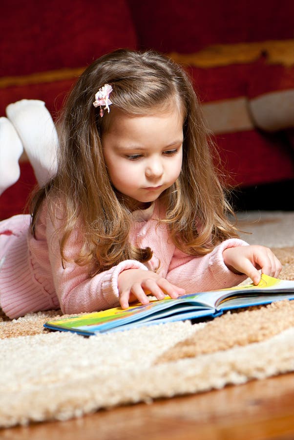 Little girl reading book stock photo. Image of female - 17152338