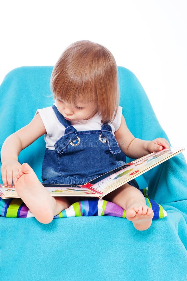 Little girl reading a book stock photo. Image of people - 19789264
