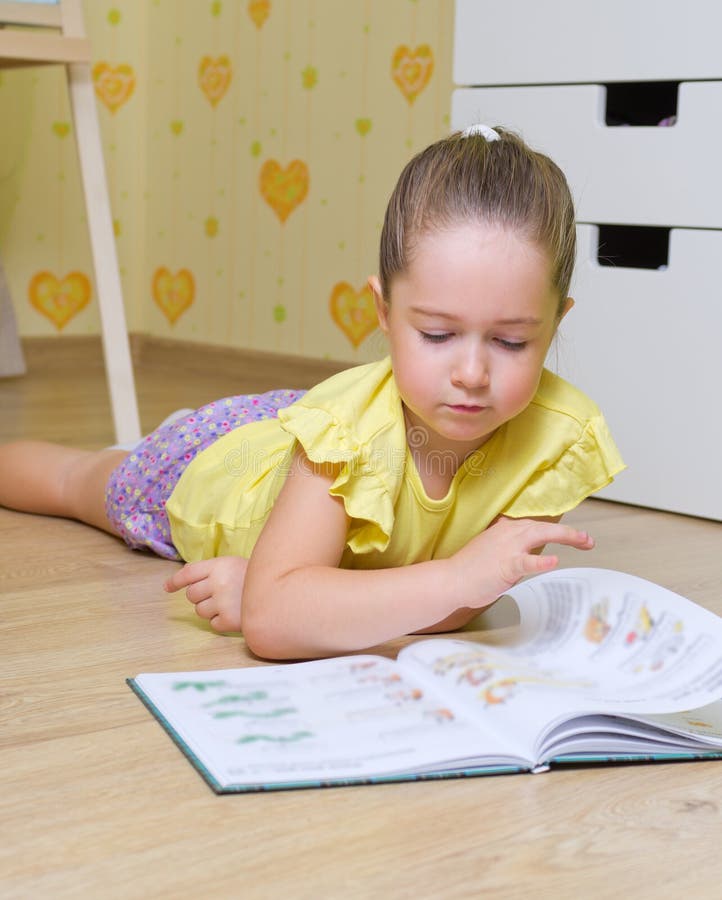 Little girl reading book stock photo. Image of floor - 27838472