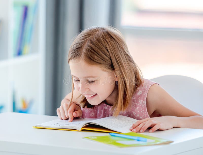 Little Girl Reading Book in Classroom Stock Image - Image of people ...