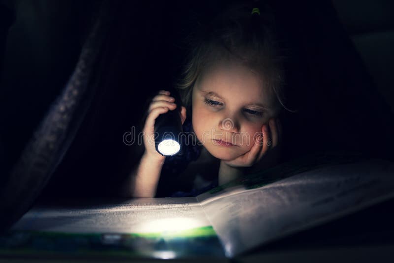 Little Girl Reading Book with Flashlight Under the Blanket Stock Image ...