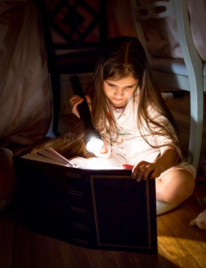 Little Girl Reading Book Under Blanket at Night Stock Photo - Image of ...