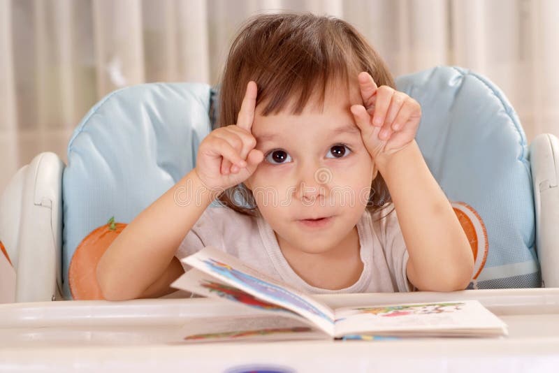 Little girl is reading stock photo. Image of closeup - 52617092