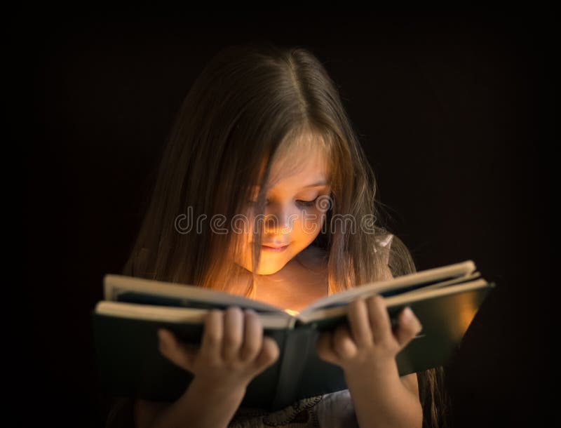 Little Girl is Reading a Magic Book Stock Photo - Image of interesting ...