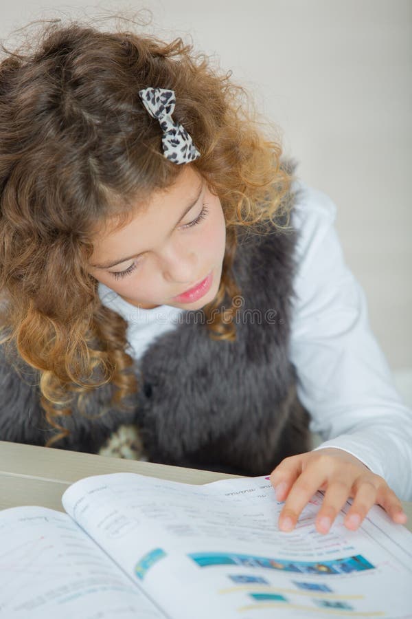 Little Girl Reading through Textbook Stock Image - Image of cognitive ...