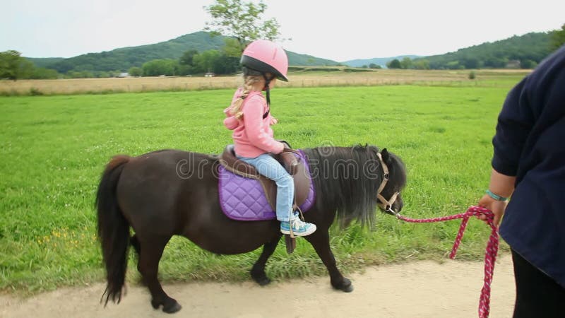 Little Girl Riding a Pony in Countryside Stock Footage - Video of ...