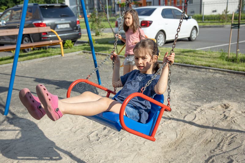 A Little Girl is Riding a Swing in the Yard Stock Image - Image of park ...