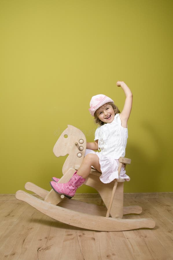 Little Girl and Rocking Horse Stock Image - Image of happy, floor: 6604699