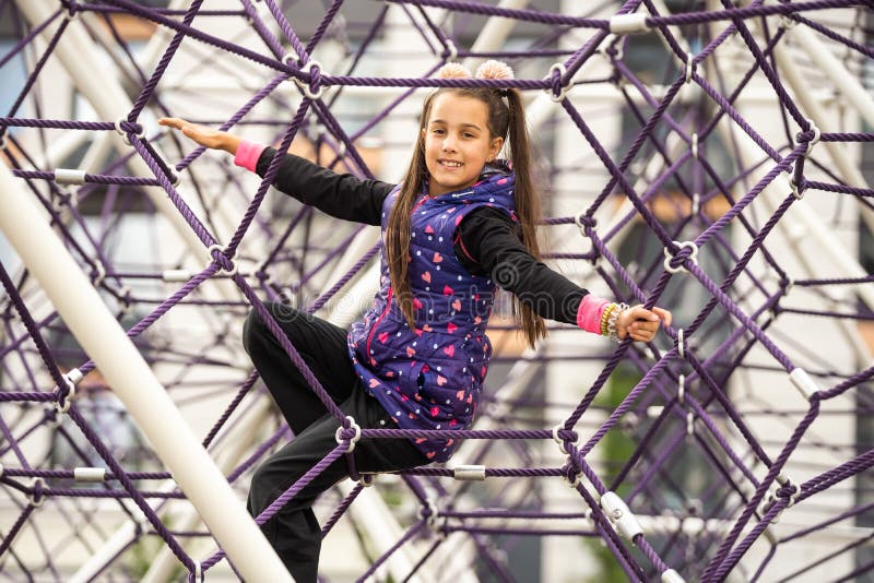 Little girl in a rope maze stock image. Image of adventure - 260338667