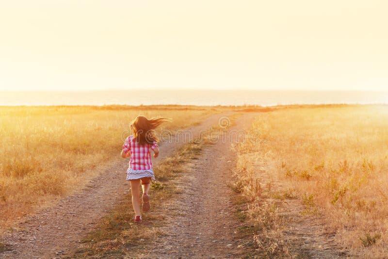 Little Girl Running in Backlit Meadow Stock Photo - Image of meadow ...