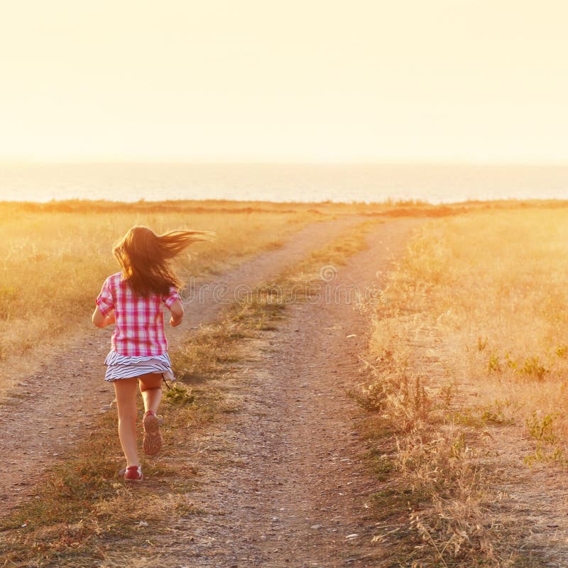 Little Girl Running in Backlit Meadow Stock Image - Image of backlit ...