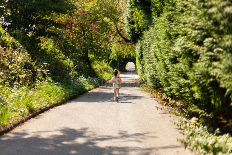 Little Girl Running on a Path in the Park on a Sunny Day Stock Photo ...