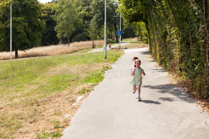 Little Girl Running on a Path in the Park on a Sunny Day Stock Image ...