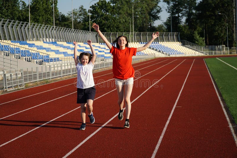 Little Girl Running on the Stadium with a Coach Stock Image - Image of ...