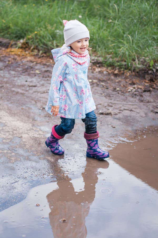 Little Girl Jumping in the Puddle Stock Photo - Image of cute, happy ...