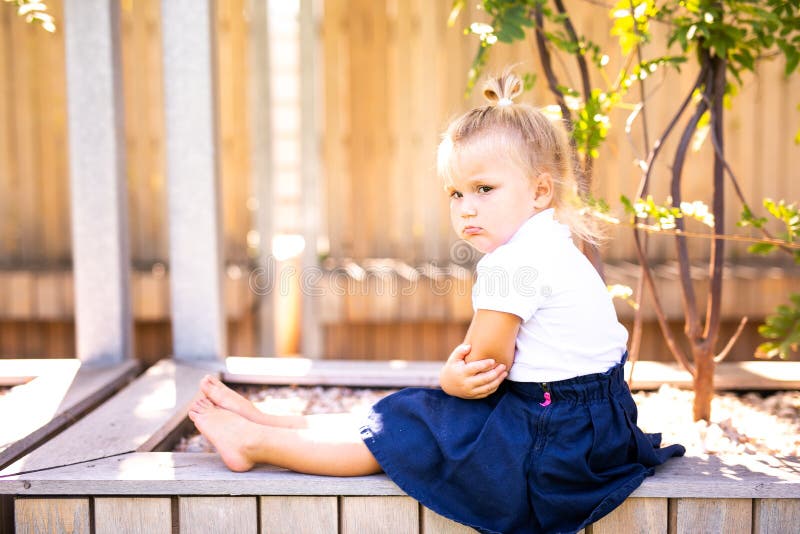 Little Girl with Sad Expression Outside. Sad Little Blonde Girl Stock ...