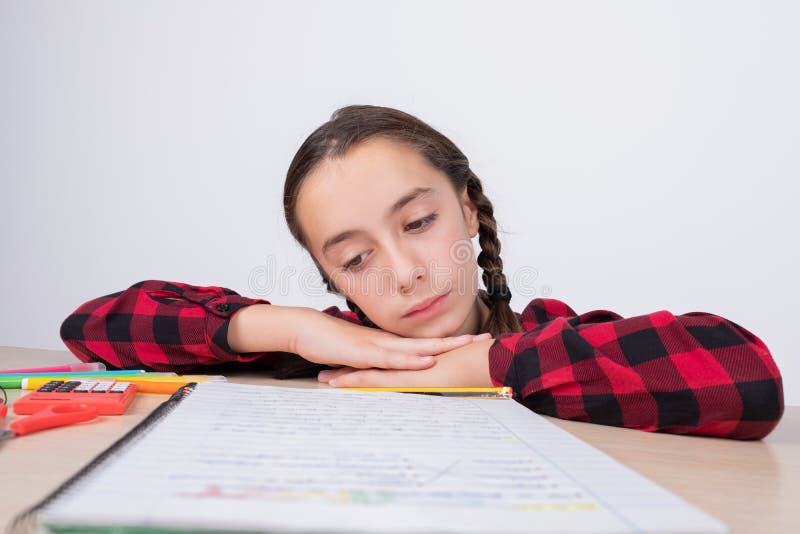 Little Girl with Sad Look Looking at Work Notebook at School Stock ...
