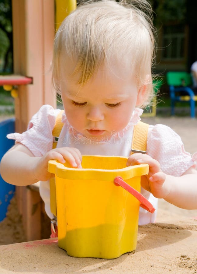 Little girl in a sandbox stock photo. Image of development - 5510428