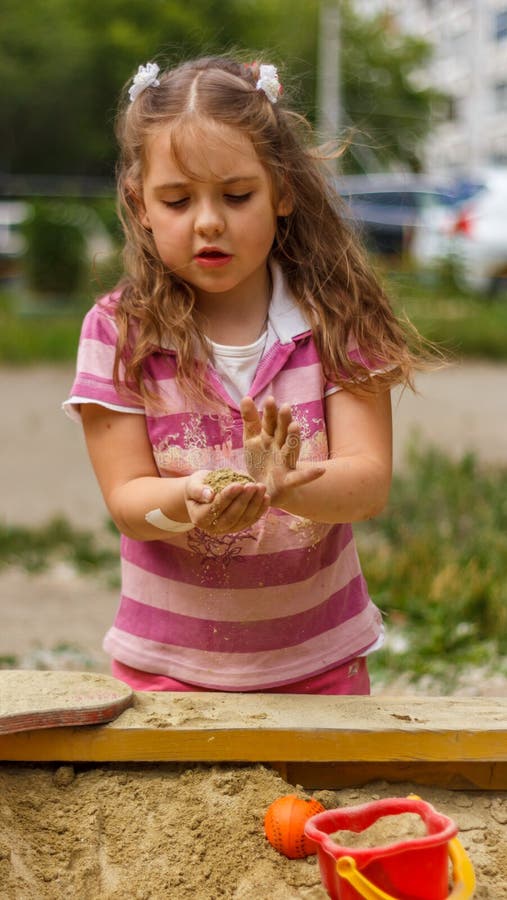 Little girl in sandbox stock photo. Image of curiosity - 32209488