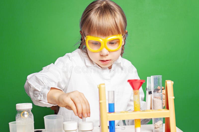 Little Girl with Science Experiments on Green Background Stock Photo ...