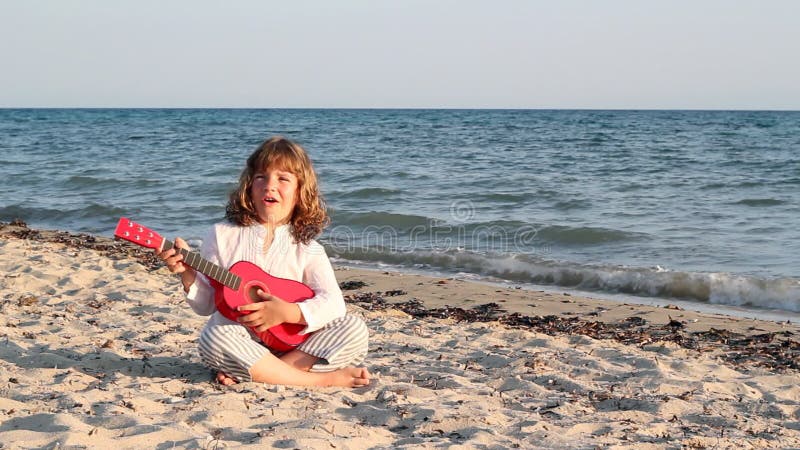 Little Girl Sing and Play Guitar Stock Video Footage - Video of ocean ...