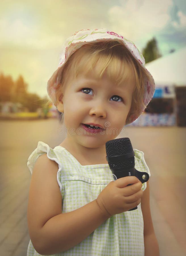 Little Girl is Singing Holding a Microphone Stock Image - Image of ...