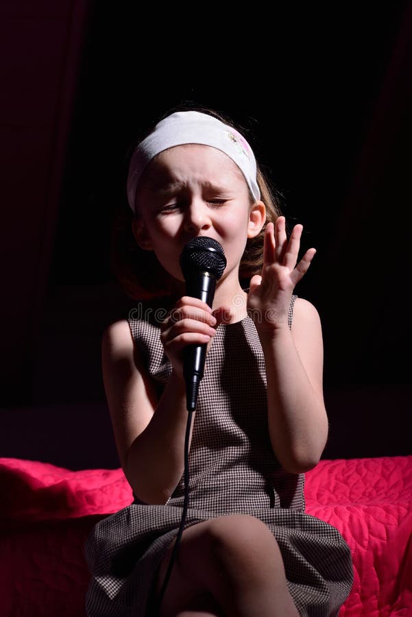 Little girl singing stock image. Image of music, black - 50772447
