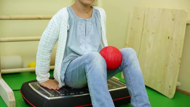 Little Girl Sits on Vibration Platform, Squeezing Stock Video - Video ...