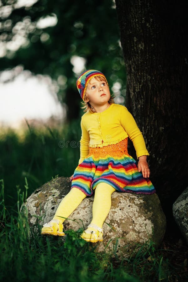Little Girl Sitting on Big Stone Stock Photo - Image of little, female ...