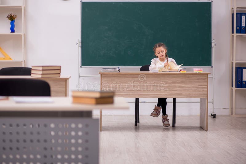 Small Girl Sitting in the Classroom Stock Photo - Image of board ...