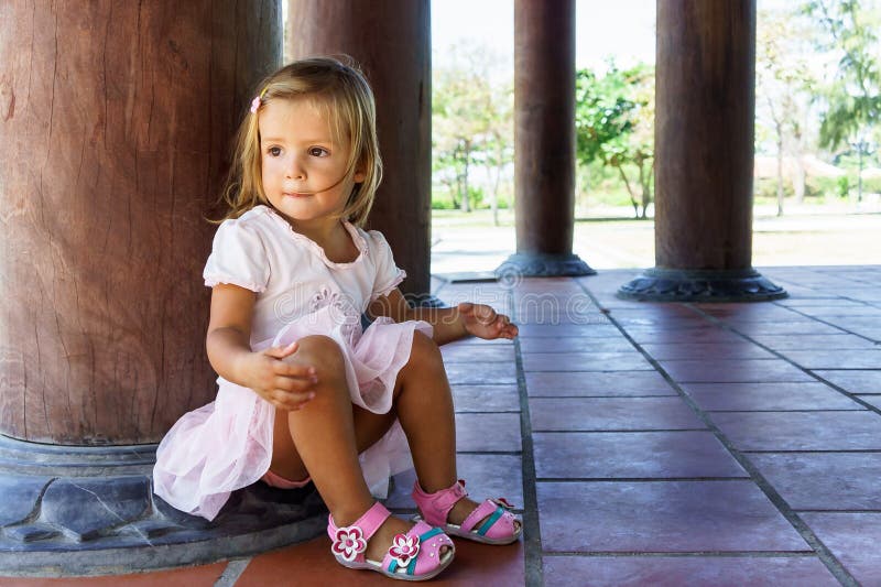 Little Girl Sitting Near the Column Stock Photo - Image of flooring ...