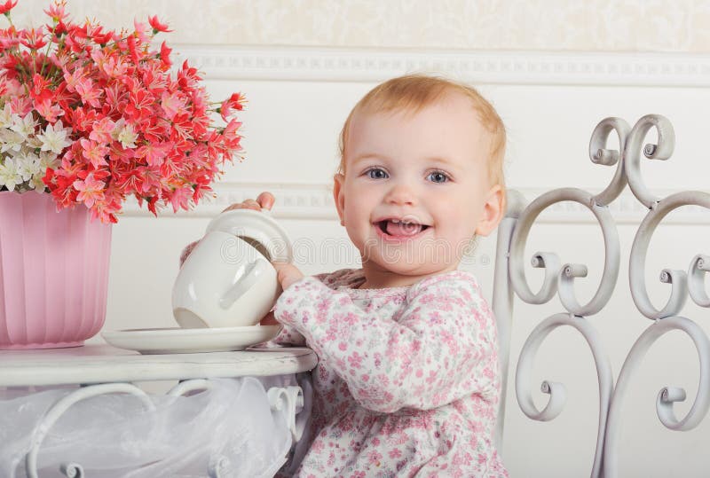 Little Girl Sitting at a Table with Tea and Decorations, Portrait ...