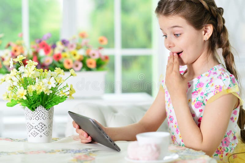 Little girl using tablet stock photo. Image of european - 99381768