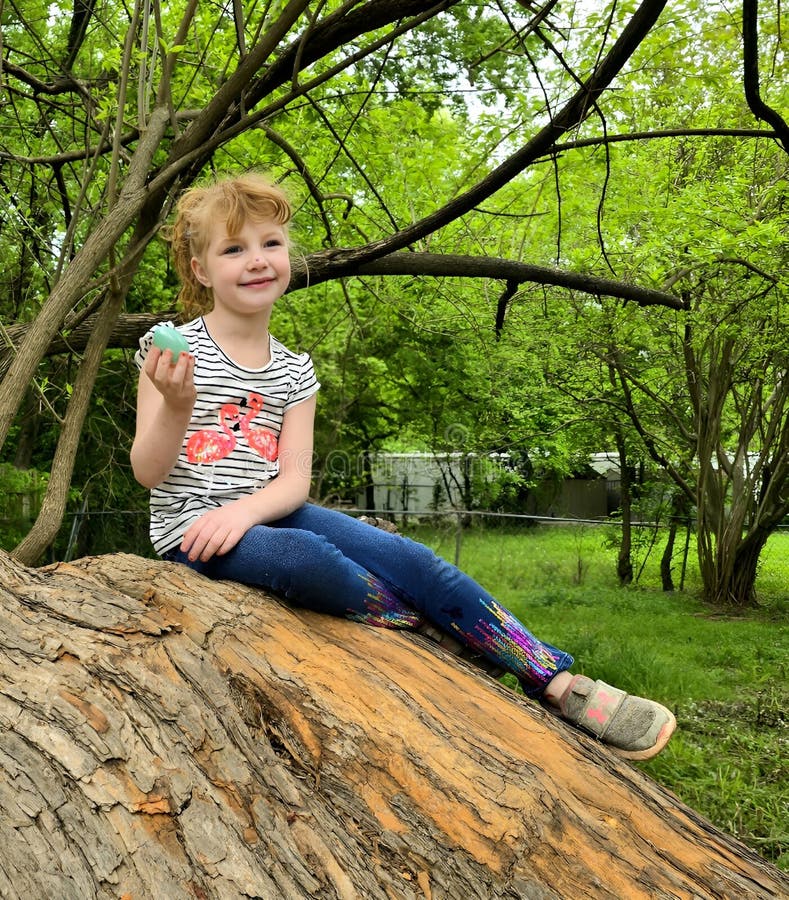 Little Girl Sitting on an Unusual Tree. Stock Image - Image of sitting ...