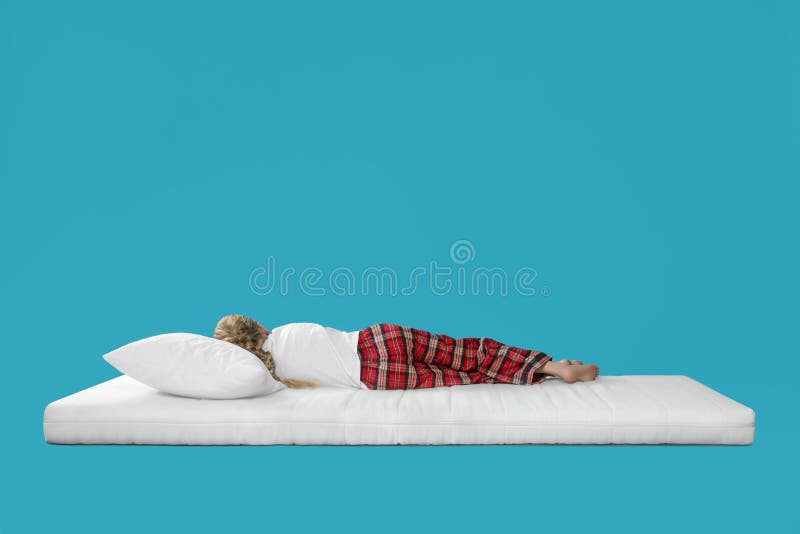 Little Girl Sleeping on Comfortable Mattress Against Light Blue ...