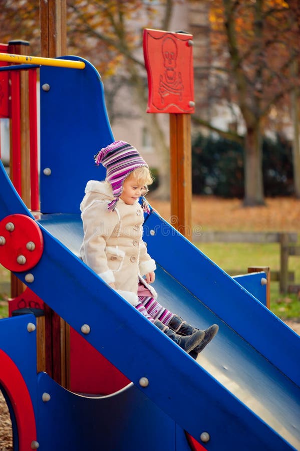 Little girl on the slide stock photo. Image of active - 23972086