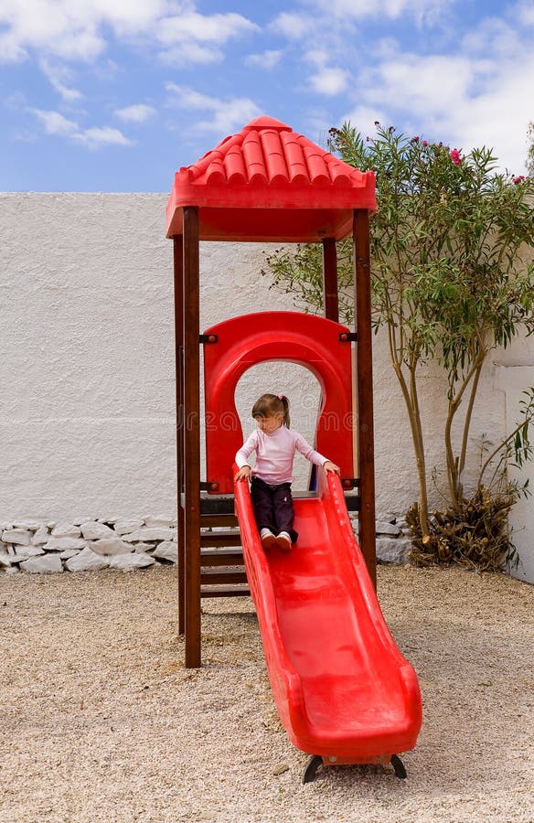 The Little Girl on the Slide at the Site. Stock Image - Image of ...