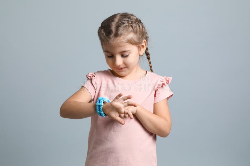 Little Girl with Smart Watch on Grey Background Stock Image - Image of ...