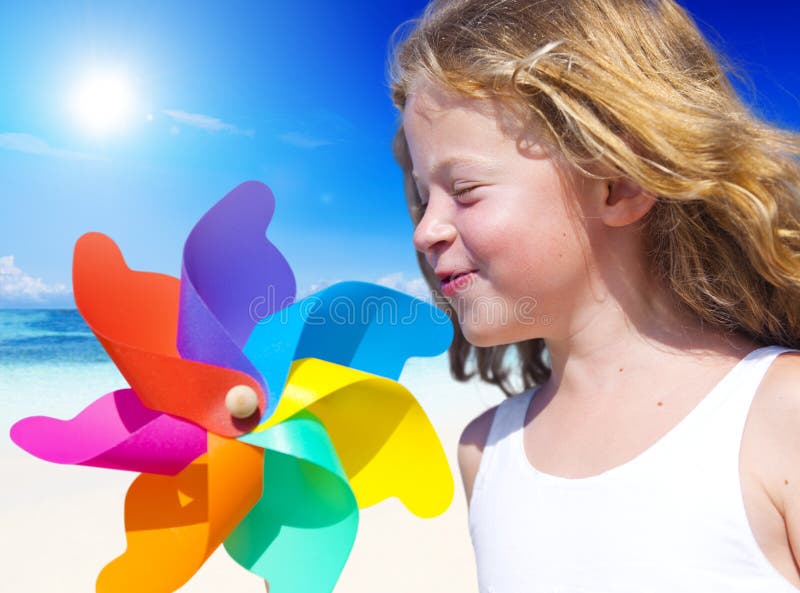 Little Girl Smiling Playing with Wind Toy Stock Photo - Image of ...