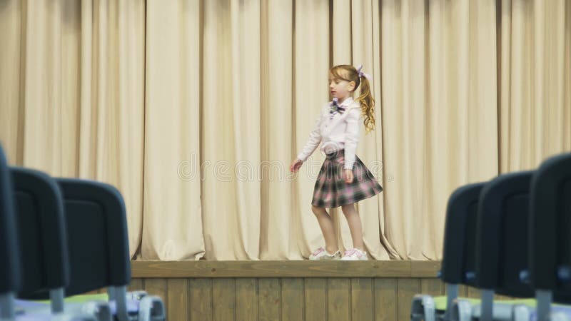 A Little Girl Goes To the Stage in an Empty Hall without People. Stock ...