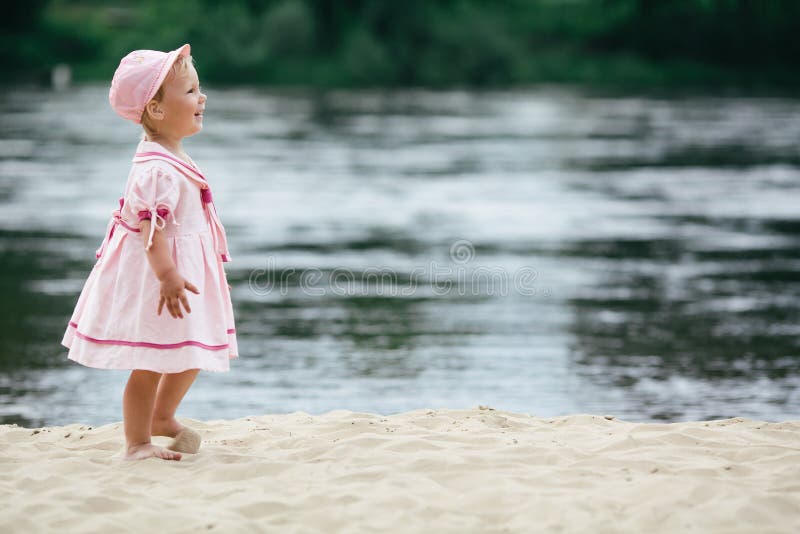 Little Girl Standing on the Coast of River Stock Photo - Image of human ...
