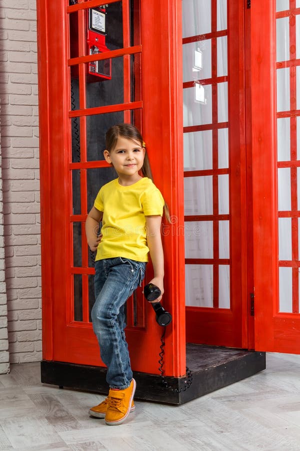 Little Girl Standing at a Phone Booth Stock Image - Image of telephone ...