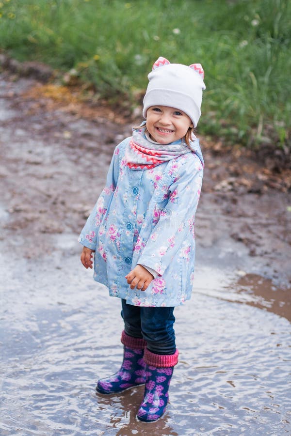 Little Girl Staying in the Puddle Stock Photo - Image of cheerful, jump ...
