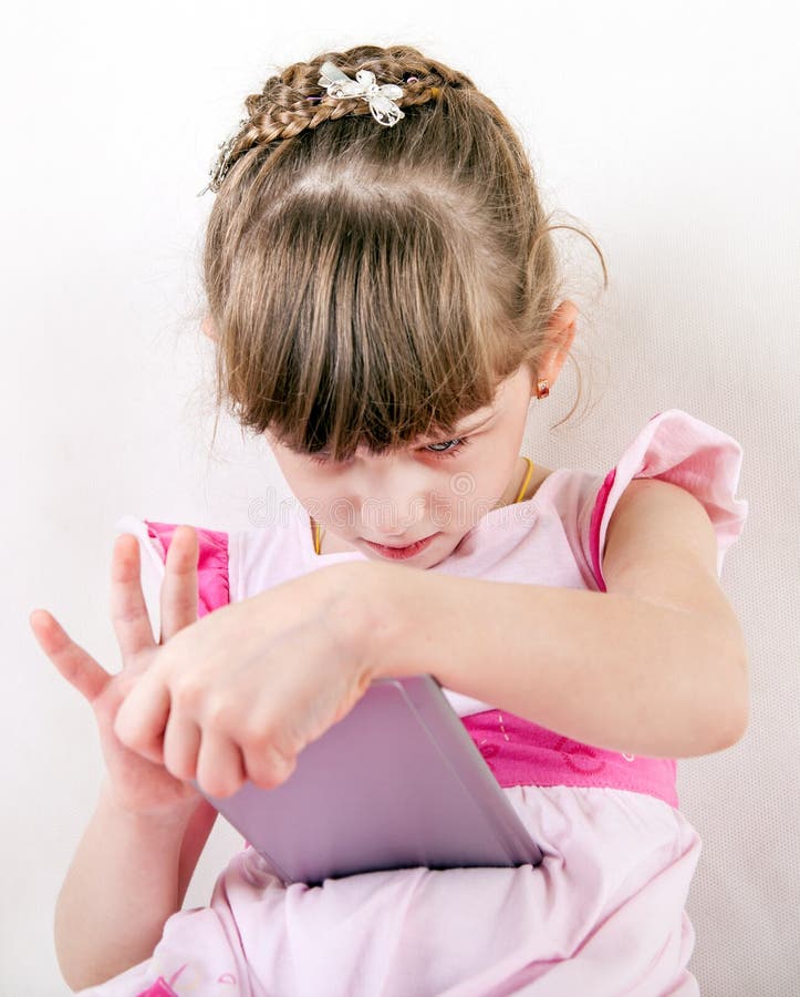 Little Girl with Tablet stock photo. Image of face, idle - 67220144