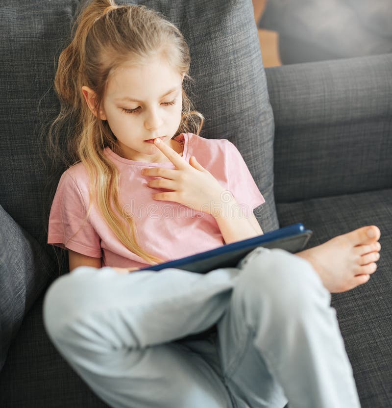 Little Girl with Tablet at Home Stock Photo - Image of caucasian, couch ...
