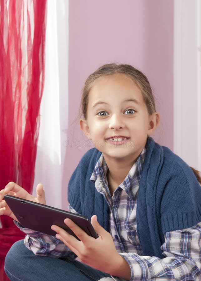 Little Girl with a Tablet Pc Stock Photo - Image of hair, girls: 34192904